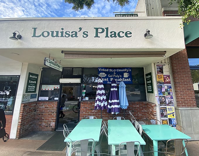 The mint-green tables outside Louisa's Place aren't just furniture—they're front-row seats to San Luis Obispo's breakfast theater, where the show always gets a standing ovation.