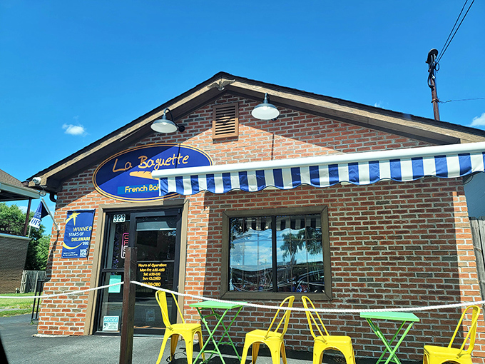 The charming brick exterior of La Baguette beckons like a Parisian postcard dropped into downtown Dover. That blue and white awning isn't just decoration—it's a promise of deliciousness.
