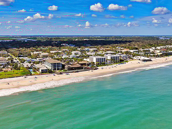 Turquoise waters meet pristine shoreline in this aerial view of Vero Beach, where paradise doesn't require a passport—just a healthy appetite for relaxation.