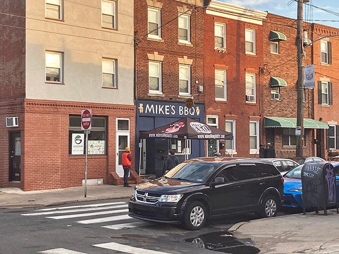 The blue storefront of Mike's BBQ stands out like a beacon of smoky hope on South 11th Street. That little pig logo knows what awaits inside.