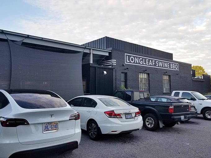 Parked cars outside hint at the treasure within – like finding a speakeasy for smoked meat enthusiasts in this modest Raleigh building.