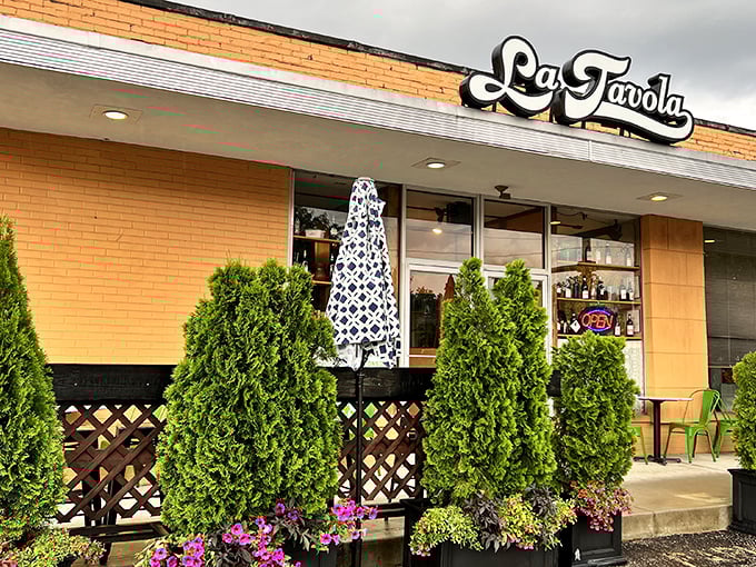 The unassuming white brick façade of La Tavola might not scream "culinary destination," but those evergreens are practically waving you in for pasta perfection.