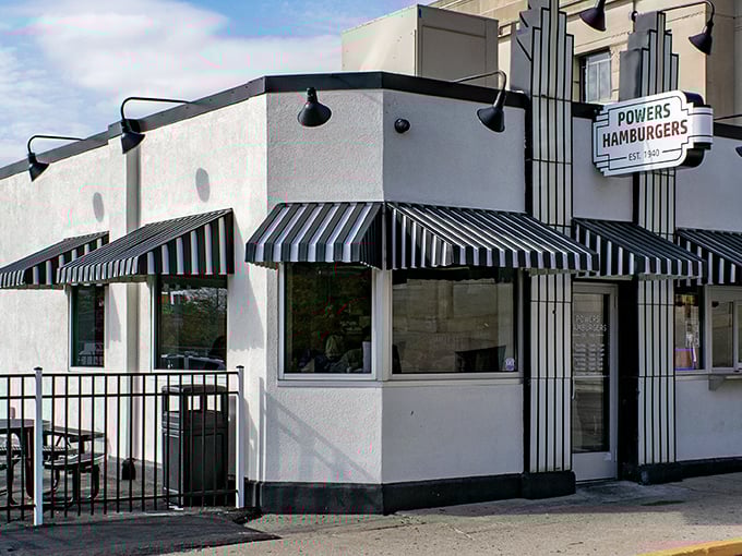 The classic white building with black and white striped awnings isn't trying to be retro—it actually is retro, because it never needed to change.