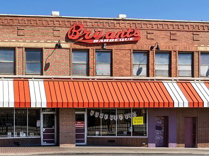 The iconic red sign against brick says it all – barbecue royalty lives here. That striped awning has welcomed hungry pilgrims for generations.