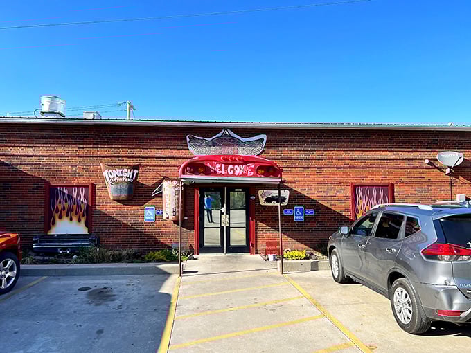The unassuming brick exterior of A Little BBQ Joint hides culinary treasures within. Those flame-painted windows aren't just decoration—they're truth in advertising.