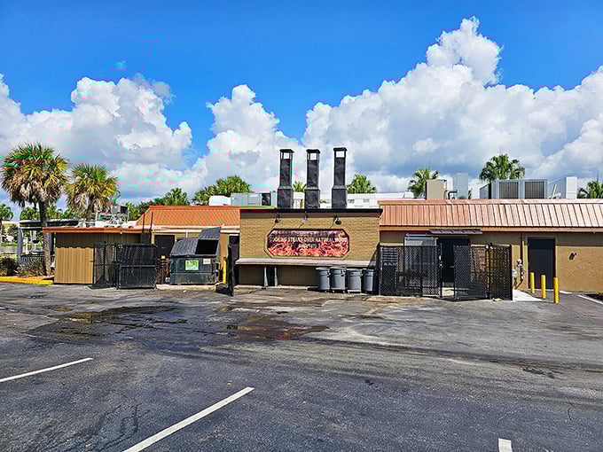 The unassuming exterior of Texas Cattle Company hides culinary treasures within. Those smokestacks aren't just for show—they're working overtime to infuse your dinner with oak-fired magic.