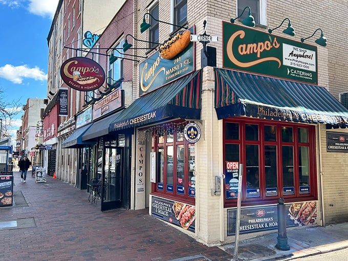 The iconic blue awning of Campo's beckons hungry pilgrims like a lighthouse guiding ships to sandwich salvation. Philadelphia's cheesesteak paradise awaits!