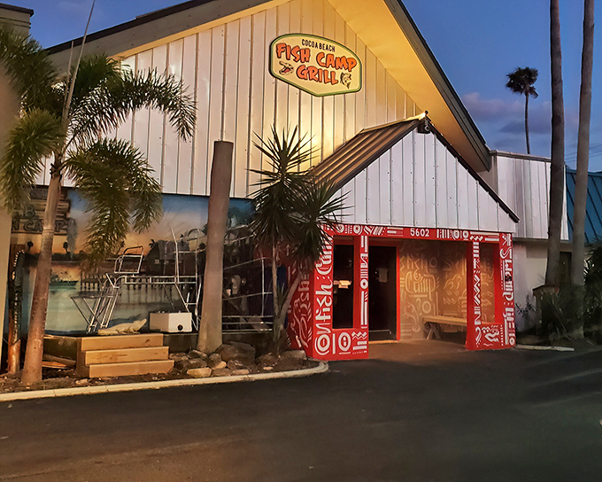 The white A-frame exterior with its vibrant red doorway isn't just inviting—it's practically shouting "Get in here and eat something delicious!" Pure Florida charm at sunset.