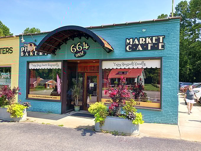 The Phoenix Bakery's teal and yellow exterior isn't just eye-catching—it's like a colorful promise of the sweet treasures waiting inside this Pittsboro gem.