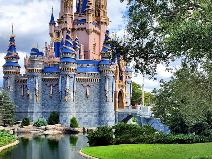 The iconic Cinderella Castle rises majestically above its reflecting moat, where fairy tales and reality blend into the perfect Florida daydream.