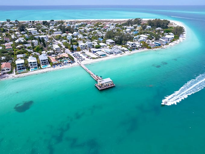 Aerial paradise where turquoise waters embrace shoreline homes. This isn't a Caribbean postcard—it's Anna Maria Island, Florida's best-kept retirement secret.