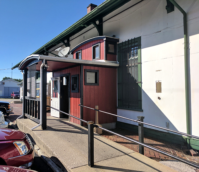 The unassuming red exterior of Depot Pizza tells you everything you need to know—this place cares more about what's inside than fancy curb appeal. 