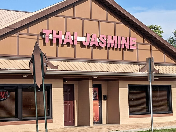 The unassuming exterior of Thai Jasmine might not stop traffic, but that pink sign promises culinary adventures that locals drive miles to experience.