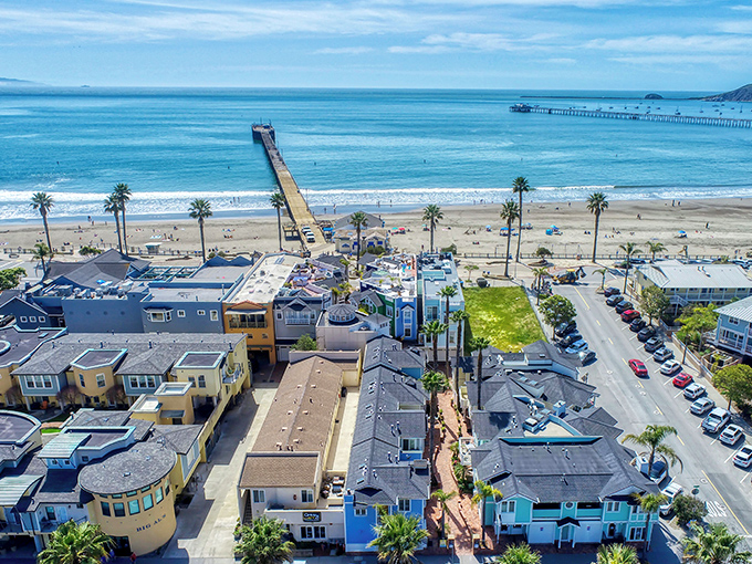 Avila Beach's colorful beachfront homes stand like a welcoming committee, with the iconic pier stretching into the Pacific like nature's own welcome mat.