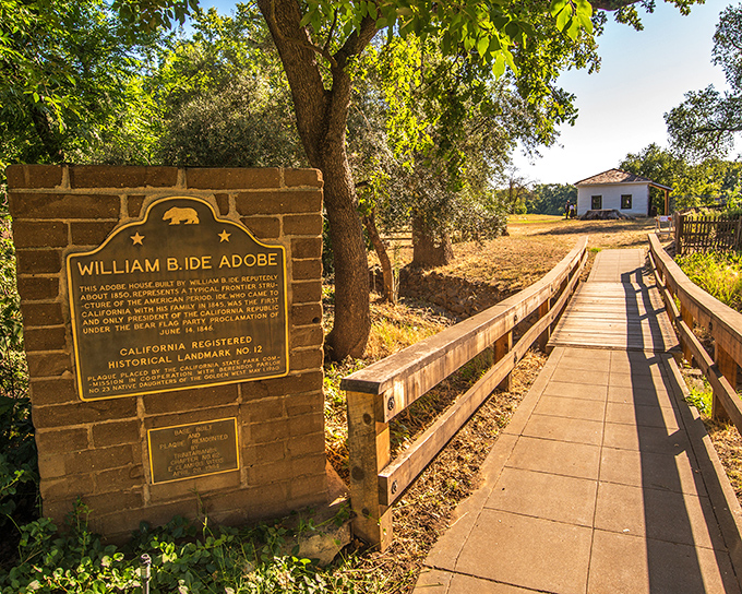 History and nature converge on this pathway, where a simple plaque marks the beginning of an unexpected journey into California's past.
