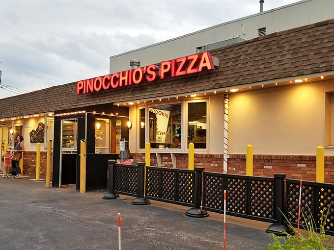 The iconic red Pinocchio's sign glows like a beacon for pizza pilgrims, promising delicious salvation after a long day