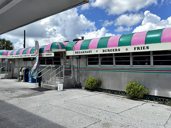 The pink and green striped awning of Angel's Dining Car isn't just eye-catching—it's a beacon of hope for hungry travelers who know what culinary treasures await inside.