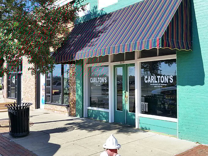 The mint-green facade with its classic striped awning isn't trying to impress anyone—it doesn't need to. The food does all the talking.