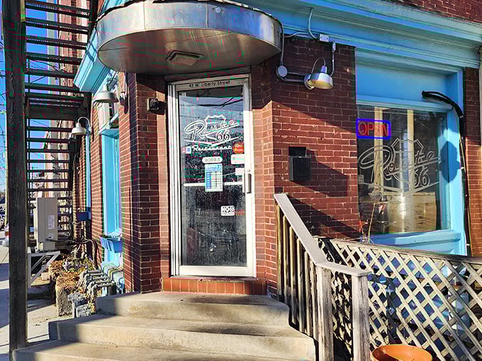 The brick facade and classic neon "OPEN" sign of Route 66 Restaurant beckons hungry travelers like a roadside oasis in Lancaster's urban landscape.