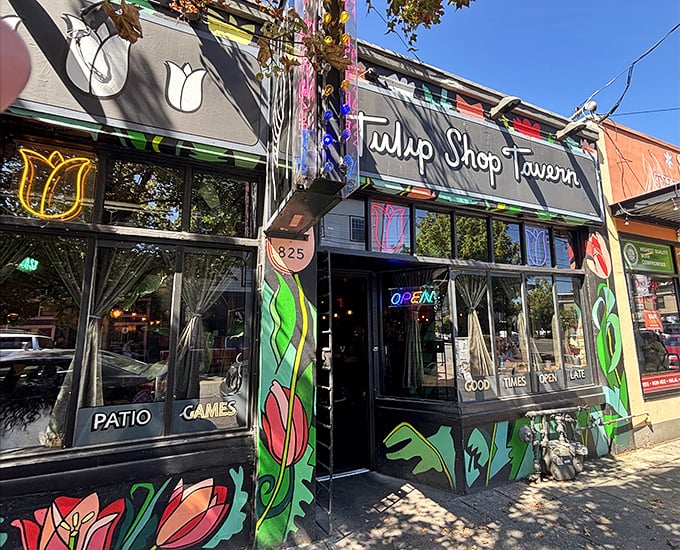 The vibrant tulip murals adorning Tulip Shop Tavern's exterior aren't just pretty decoration—they're a promise of the colorful flavors waiting inside this North Portland gem.