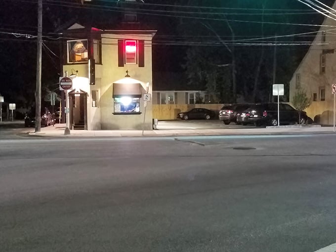 The corner beacon of culinary delight stands illuminated against the night sky, beckoning hungry travelers with its warm glow and promise of cheesesteak perfection.