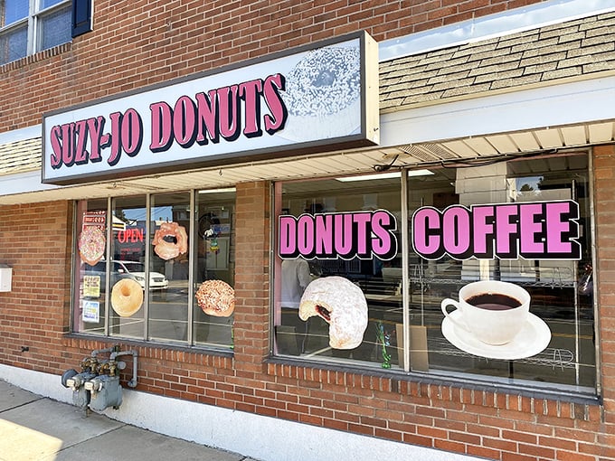 Morning sunshine illuminates Suzy-Jo's welcoming facade, where those donut decals in the window aren't just decoration—they're a delicious promise waiting to be fulfilled.