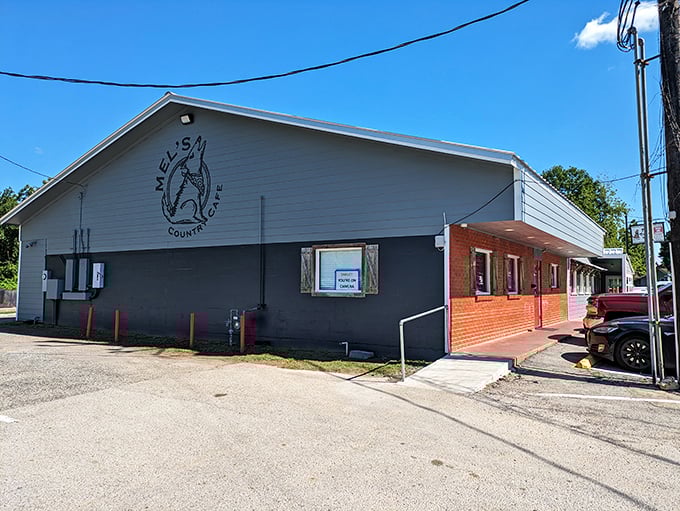 The unassuming exterior of Mel's Country Cafe proves once again that the best Texas treasures don't need fancy facades—just that red and white awning signaling "good food ahead."