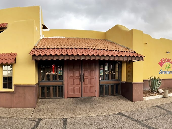 Those wooden double doors aren't just an entrance—they're a portal to flavor town. The terracotta roof and adobe-style walls set the stage for the culinary performance waiting inside.