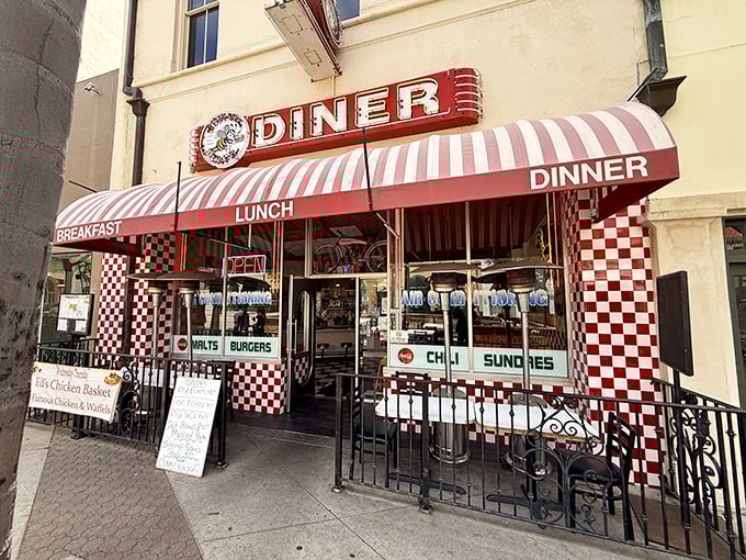 The red and white checkerboard facade isn't just eye-catching—it's a time portal to when Elvis topped charts and milkshakes came with two straws.