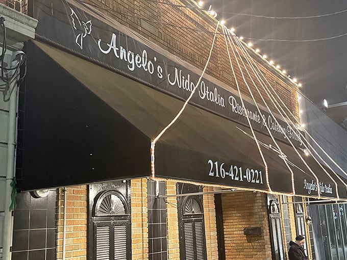 The unassuming brick exterior of Angelo's Nido Italia beckons like an old friend, promising culinary treasures behind its classic awning and modest façade.