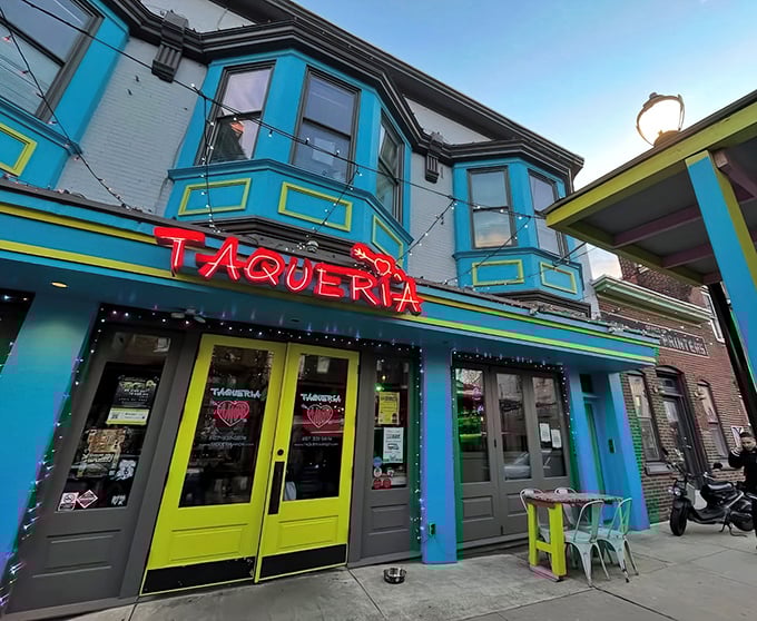 The turquoise and yellow façade of Taqueria Amor isn't just a restaurant entrance—it's a mood-lifting color therapy session that promises delicious things inside.