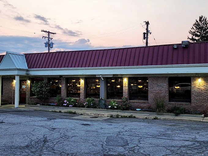 As dusk settles, George's Kitchen's warm glow promises refuge from the day—a burgundy-roofed sanctuary where hungry souls find solace in homestyle cooking.
