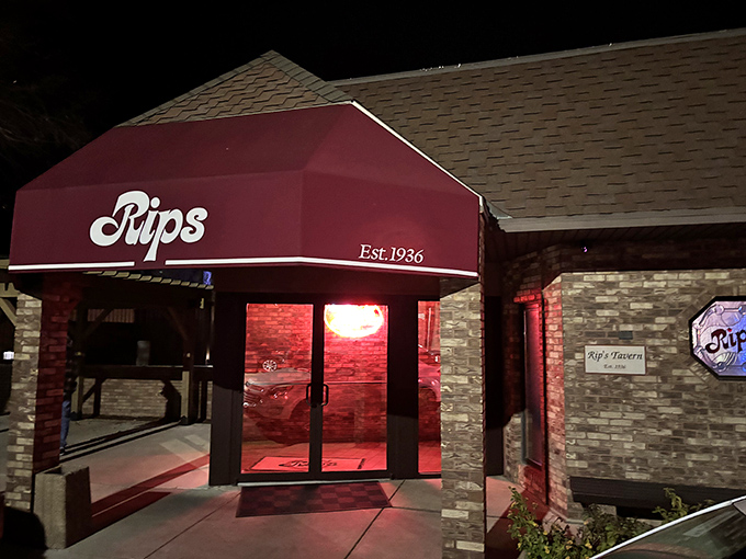 The iconic red awning of Rip's Tavern stands as a beacon of fried chicken perfection in tiny Ladd, Illinois—a pilgrimage site disguised as a neighborhood tavern.