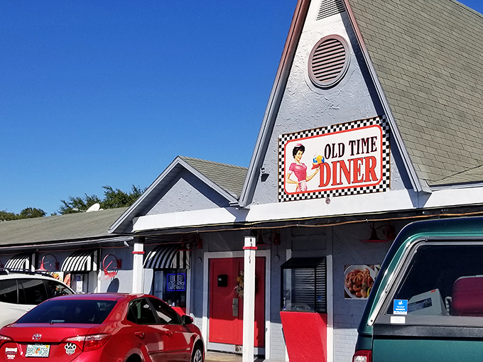 The iconic A-frame roof of Old Time Diner stands like a beacon of breakfast hope against the Florida sky, promising nostalgic flavors and zero pretension.