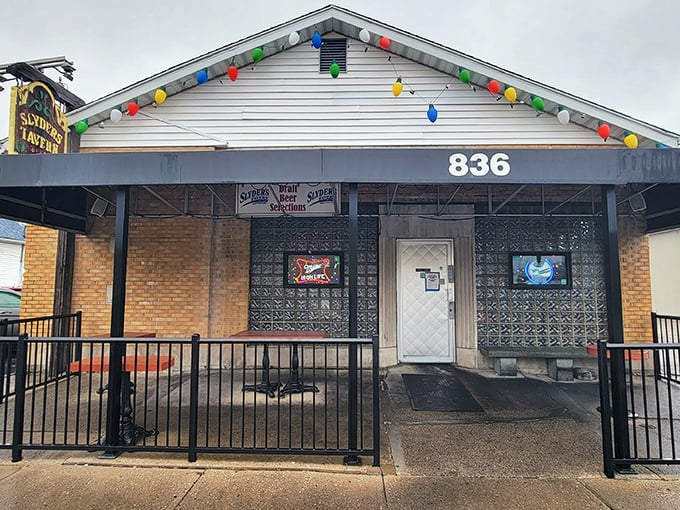 The unassuming exterior of Slyder's Tavern stands as a beacon to burger lovers, its vintage sign promising simple pleasures: liquor, beer, and unforgettable food.