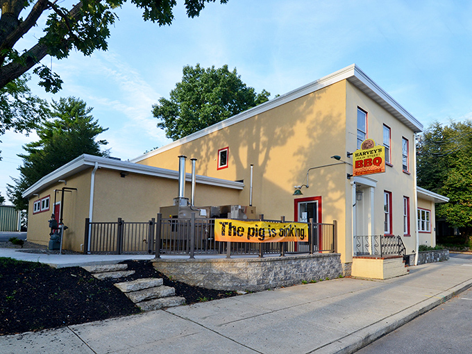 The unassuming yellow exterior of Harvey's Main Street BBQ stands like a beacon of smoky promise on Mount Joy's Main Street.