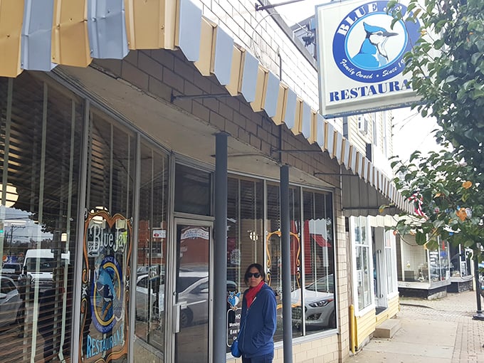 The iconic Blue Jay Restaurant storefront stands as a beacon of Cincinnati culinary tradition, its vintage sign promising comfort food treasures within.