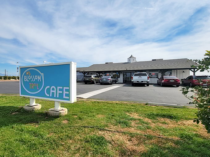 The cheerful blue sign welcomes hungry travelers like a beacon of breakfast hope along the rural highway. California sunshine included at no extra charge!