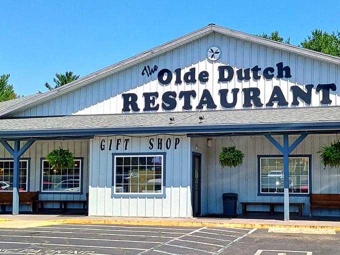 The white clapboard exterior of Olde Dutch Restaurant stands like a beacon of comfort food promise in Logan, Ohio—complete with hanging plants that somehow survive despite being constantly tempted by pie aromas.