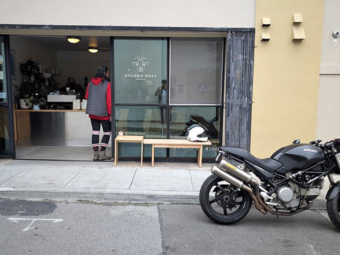 The unassuming storefront belies the treasures within—minimalist design with that distinctive goat logo promising caffeinated delights ahead.