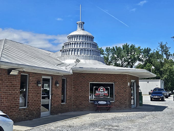 That's not a spaceship landing in rural North Carolina—it's barbecue royalty announcing itself with an iconic silver Capitol dome atop humble brick walls.
