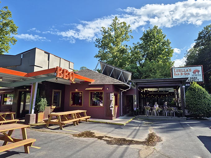 Rustic charm meets barbecue brilliance at Luella's exterior, where that glowing BBQ sign promises smoky treasures within.