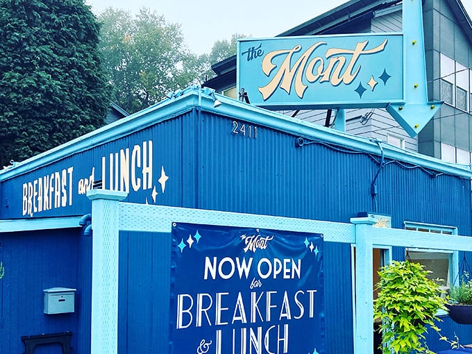 The Mont's vibrant blue exterior isn't just a building—it's a promise of good things to come, standing like a delicious beacon on Belmont Street.