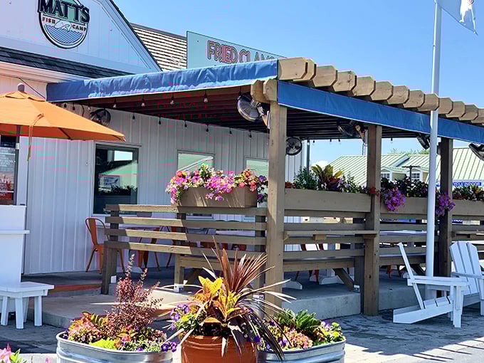 The welcoming facade of Matt's Fish Camp beckons with coastal charm, colorful flower boxes, and a promise of seafood that'll make you forget your table manners.