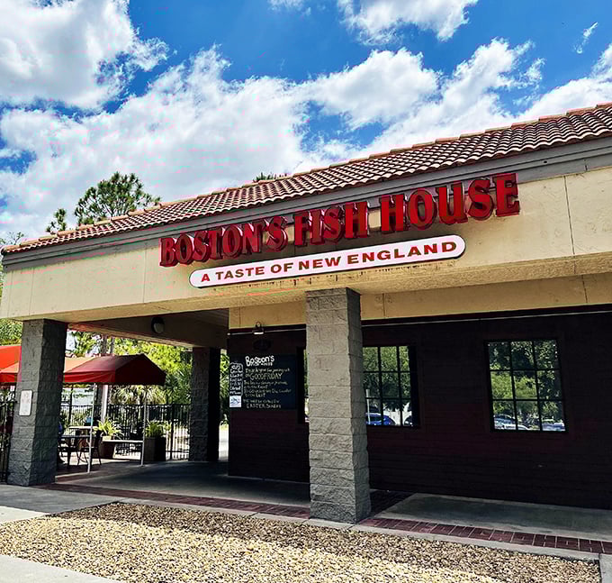 The bold red letters against the Florida sky promise New England treasures within—like finding a Red Sox cap at a beach party.