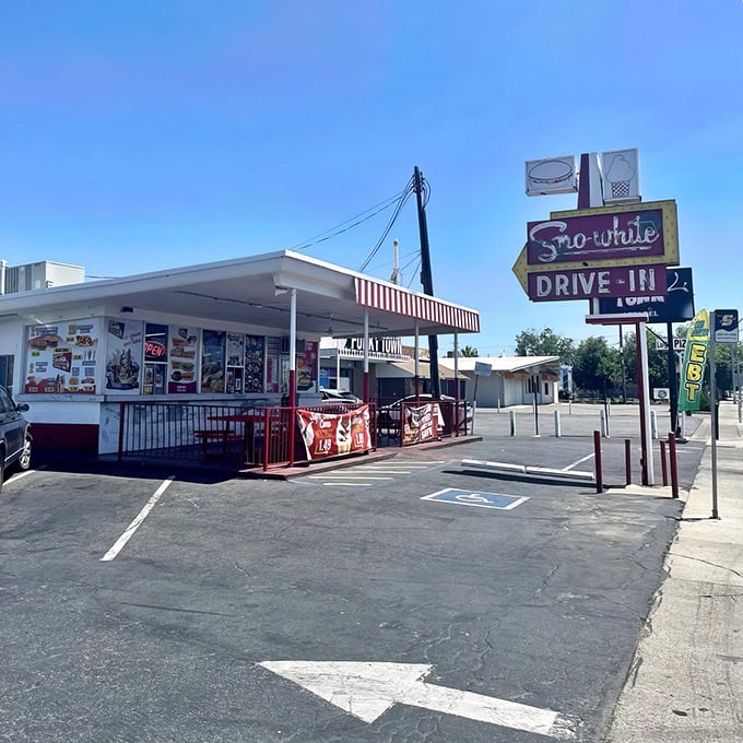 That iconic Sno-White sign against the blue California sky isn't just advertising—it's a time portal to when burgers were simple and sublime.