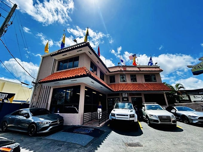 The pink stucco exterior of Garcia's with its Spanish-style roof tiles and colorful nautical flags stands as Miami's seafood beacon—no neon required.