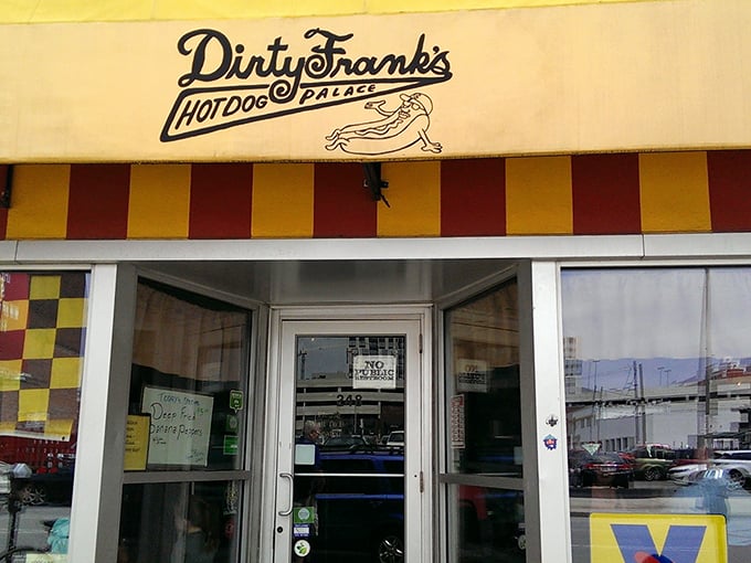 The iconic yellow and red striped awning of Dirty Frank's beckons like a carnival of culinary delights waiting to happen. 