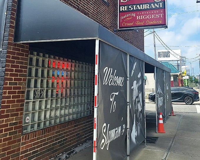 The unassuming brick exterior of Slyman's hides Cleveland's sandwich royalty. That red sign promising "Cleveland's BIGGEST Corned Beef Sandwich" isn't kidding—it's a delicious warning.