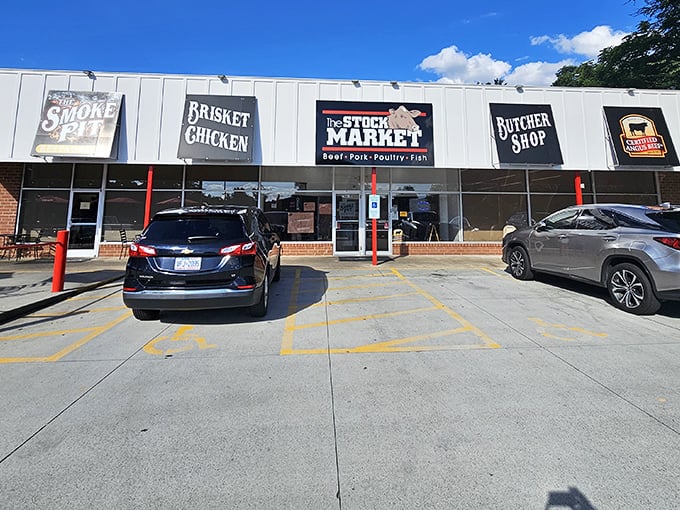 The unassuming strip mall exterior of The Smoke Pit—proof that the best barbecue joints often hide in plain sight.